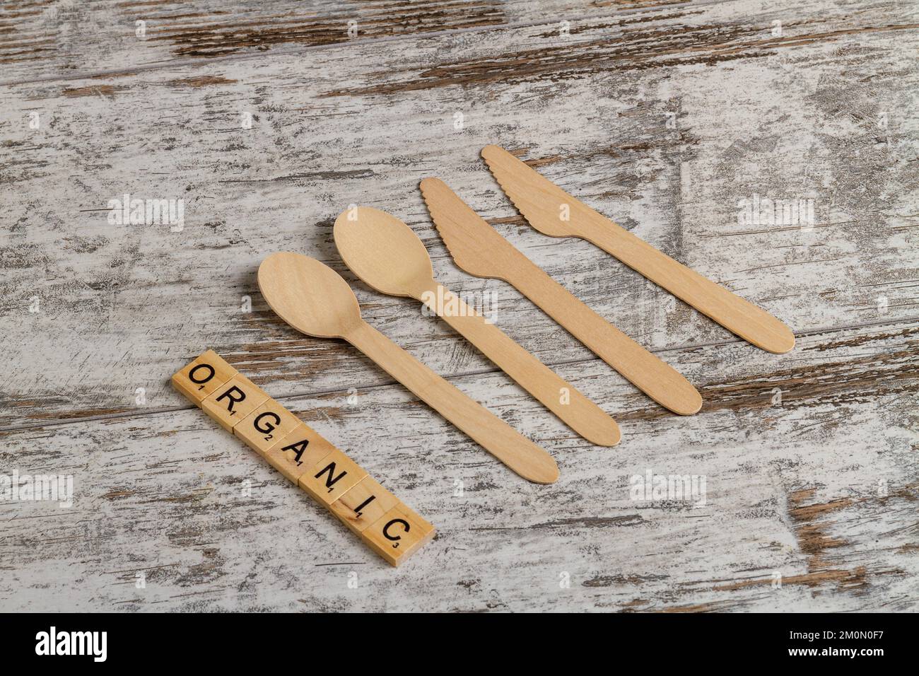 Rural wooden spoons and knives top view. Organic word made of cubes ...