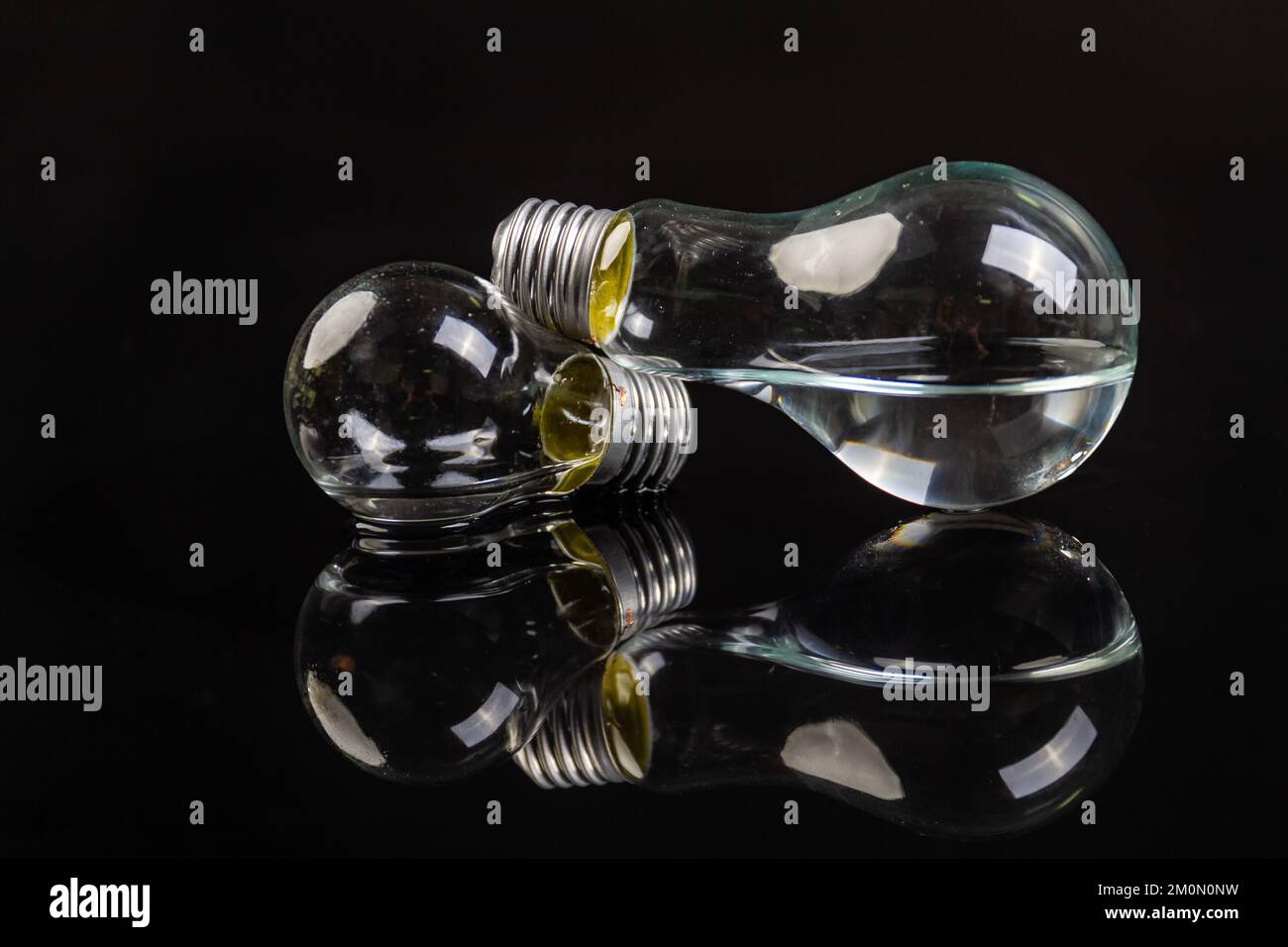 Two turned off light bulbs on black background with reflection Stock ...