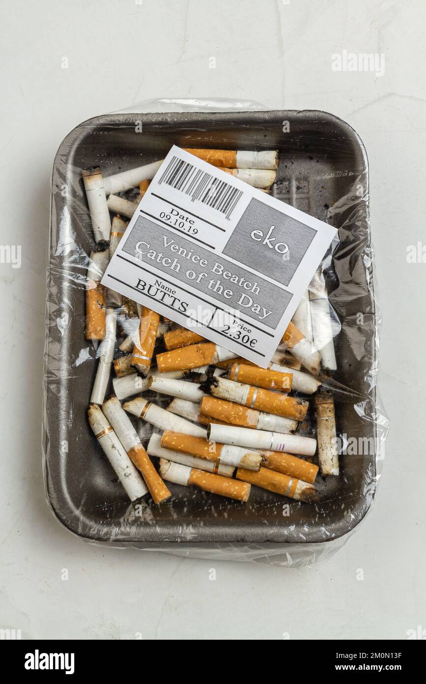 Top view plastic wrapped pile of used cigarettes. Vertical shot white ...