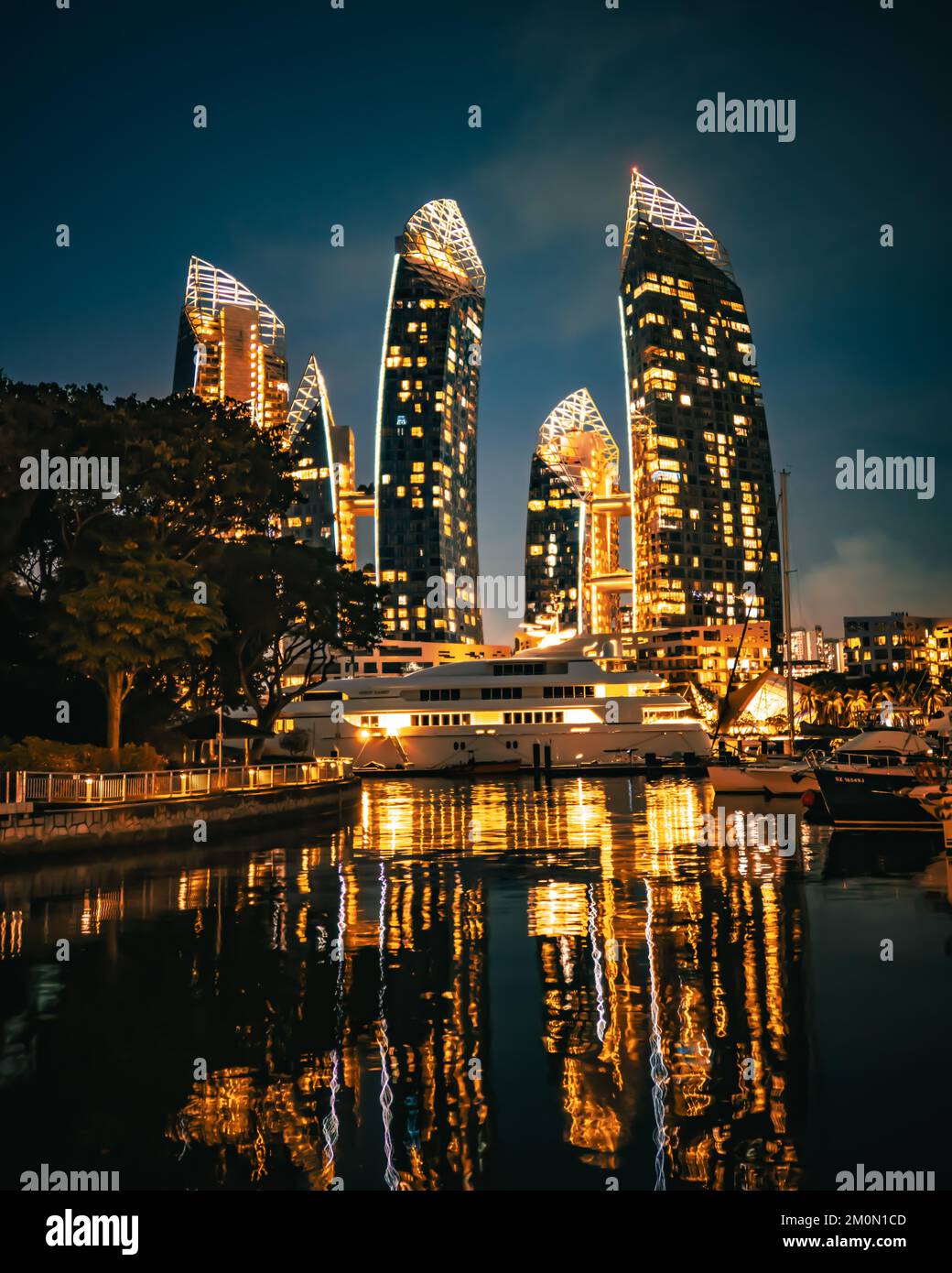 A vertical shot of Reflections at Keppel Bay at night. A luxury ...