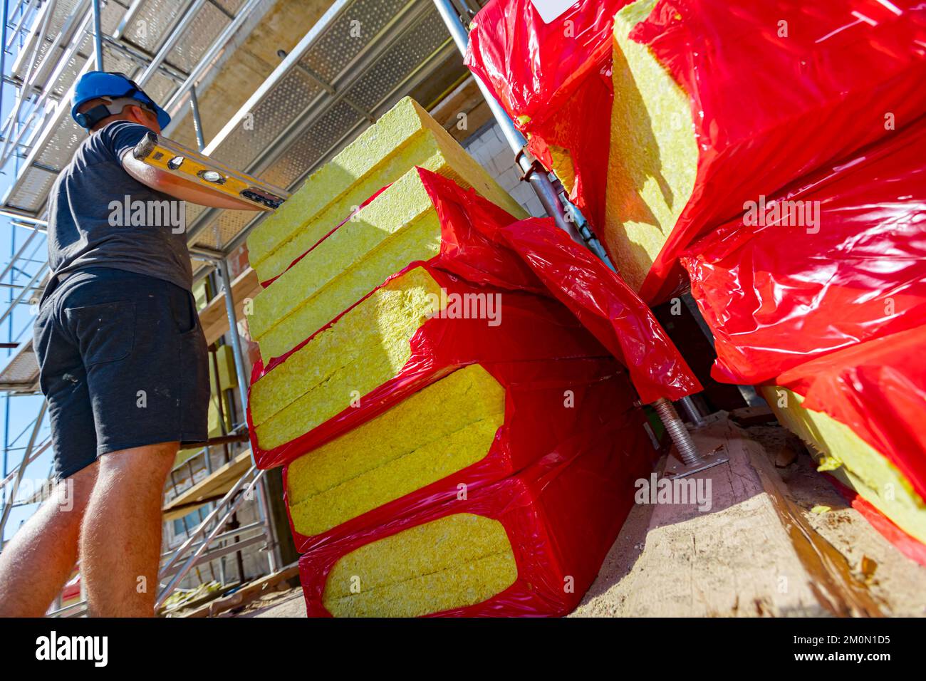 Boss oversees, controls work on construction site. Packages of thermal ...