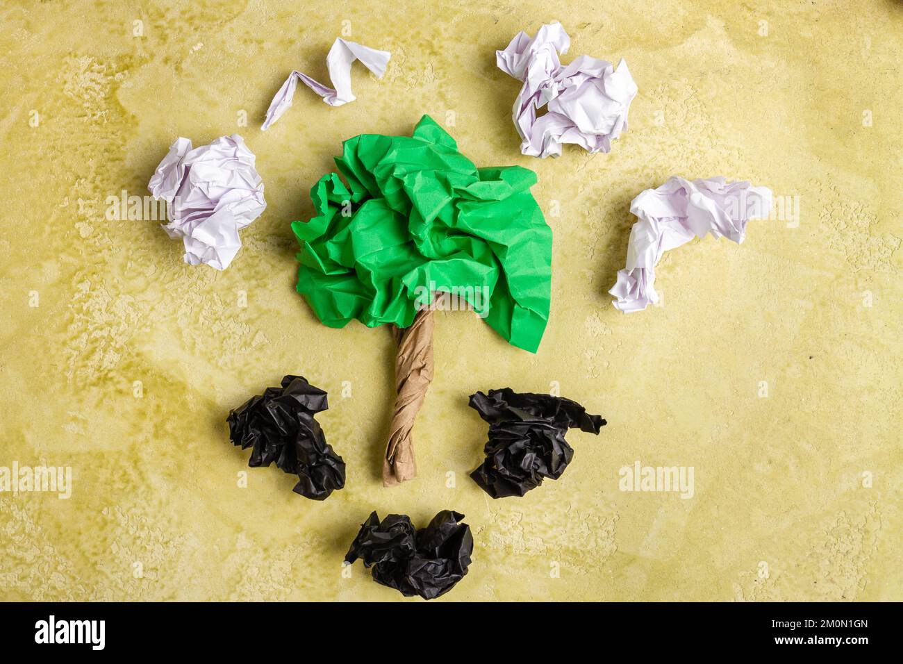 Green crumpled paper in shape of tree. White and black papers ...