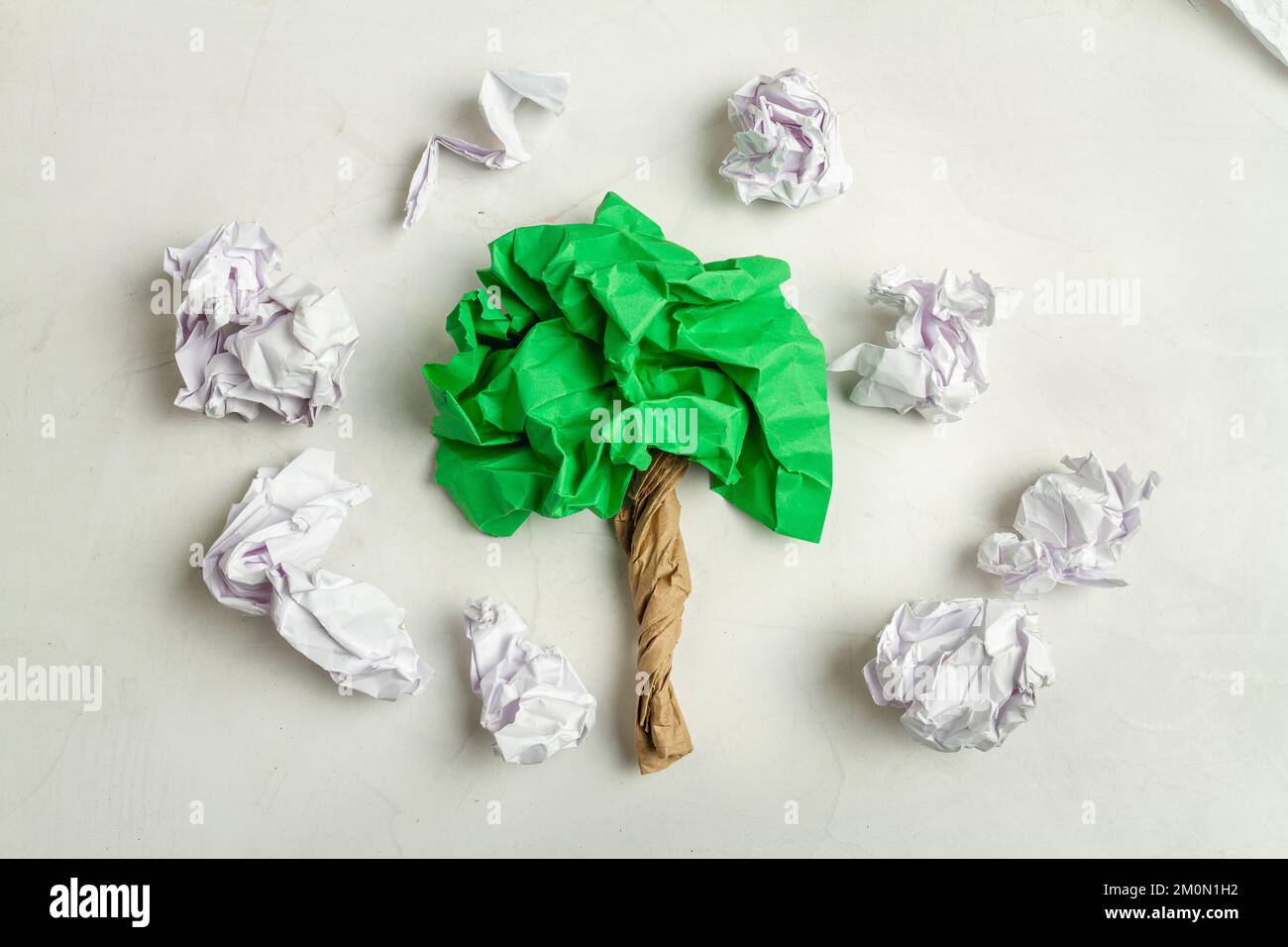 Top view of green crumpled paper in shape of tree. Enviroment pollution ...
