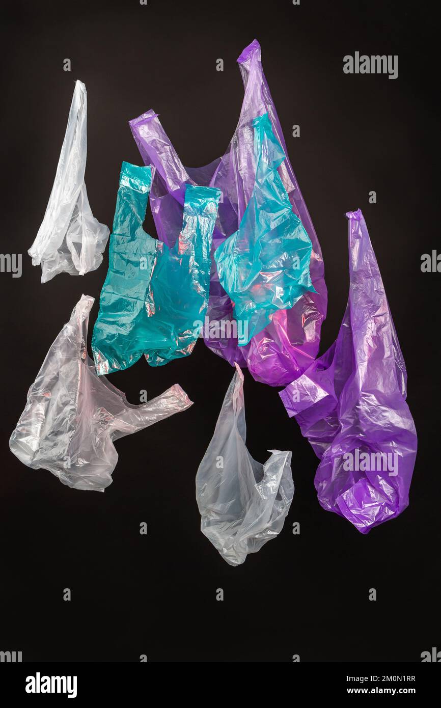 Vertical shot collection of colorful plastic bags. Isolated on black ...