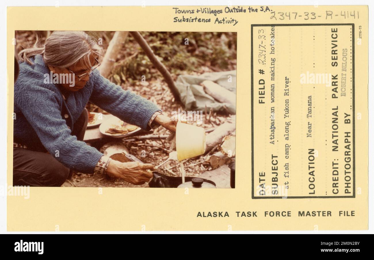 Athapaskan woman making hotcakes at fish camp along Yukon River. Alaska ...