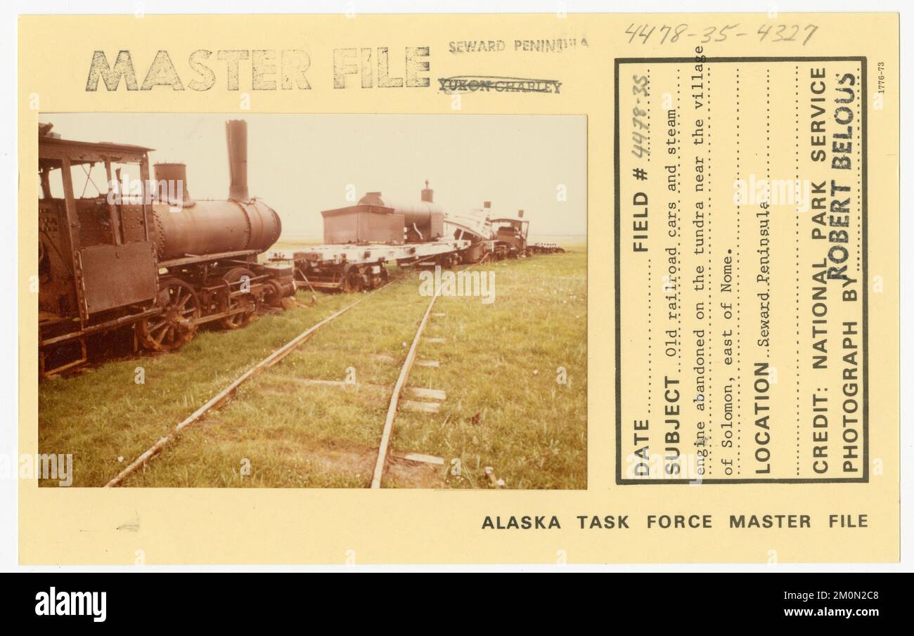 Old railroad cars and steam engine abandoned on the tundra near the ...