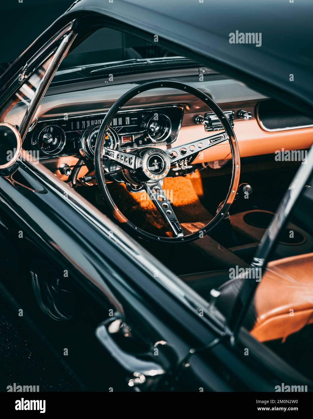 A vertical view of the interior of Ford Mustang GT350 with orange ...