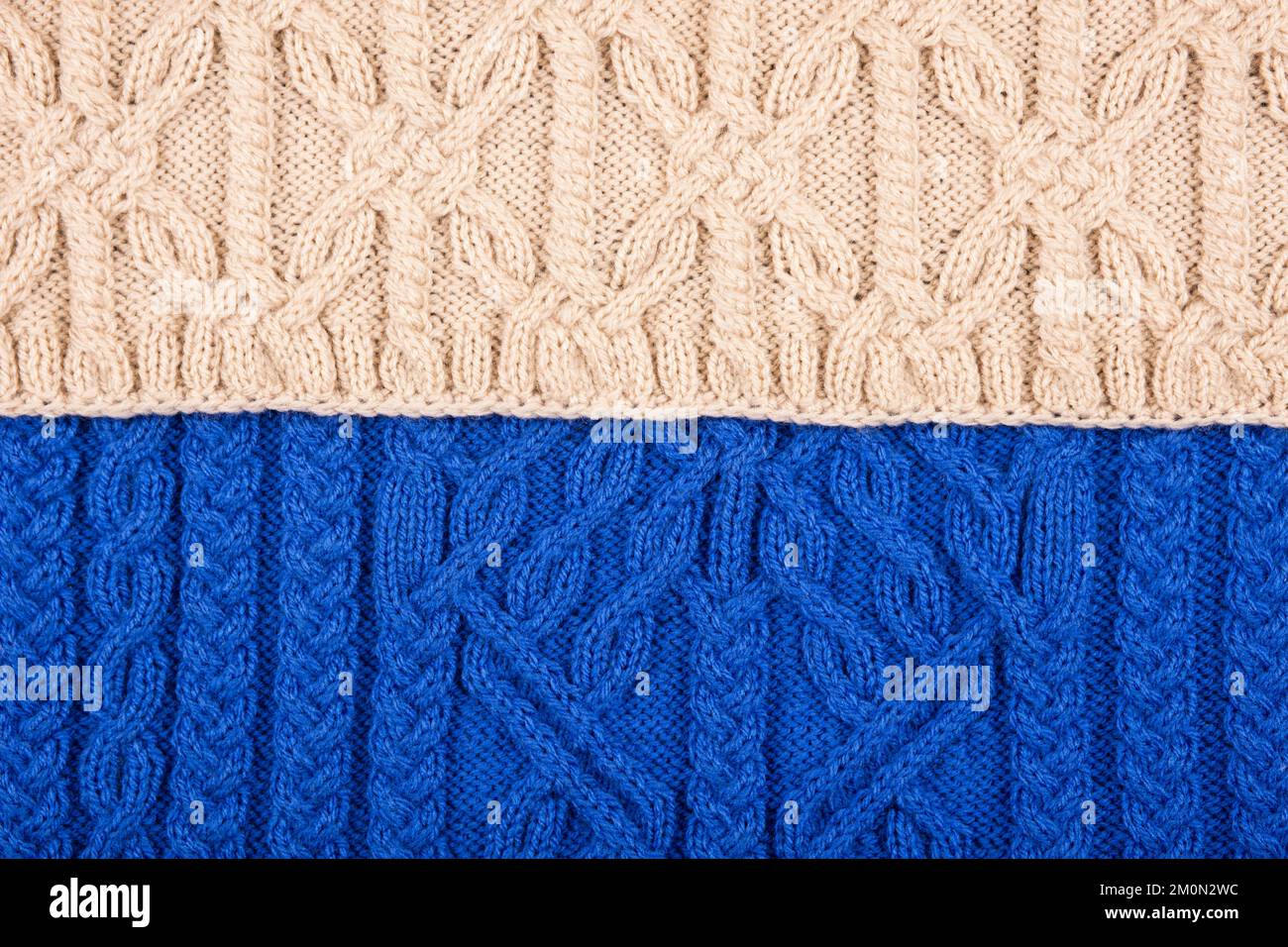 Knitted blue and beige background. Large knitted fabric with a pattern ...