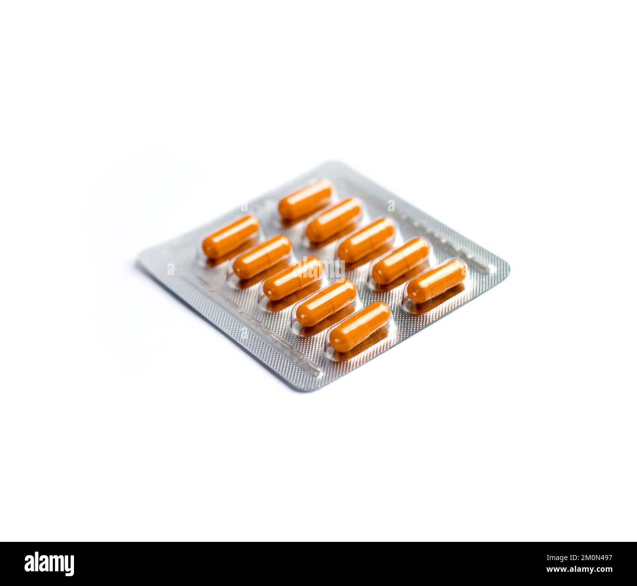 Orange pill capsules in blister pack isolated on white background ...