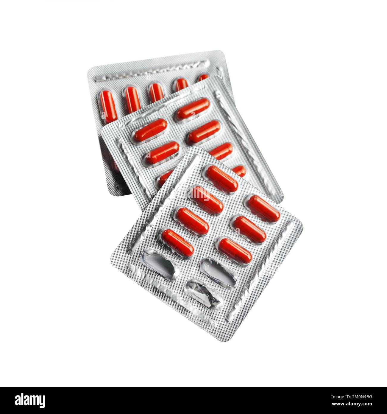 Red pill capsules in blister packs isolated on white background with ...