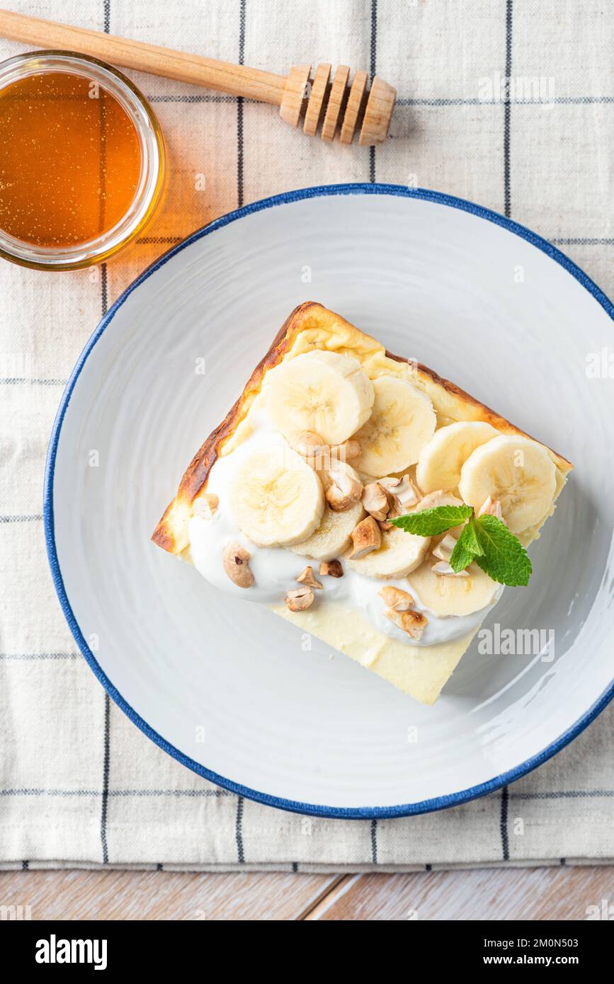 Slice of cottage cheese cake casserole served with yogurt, banana ...