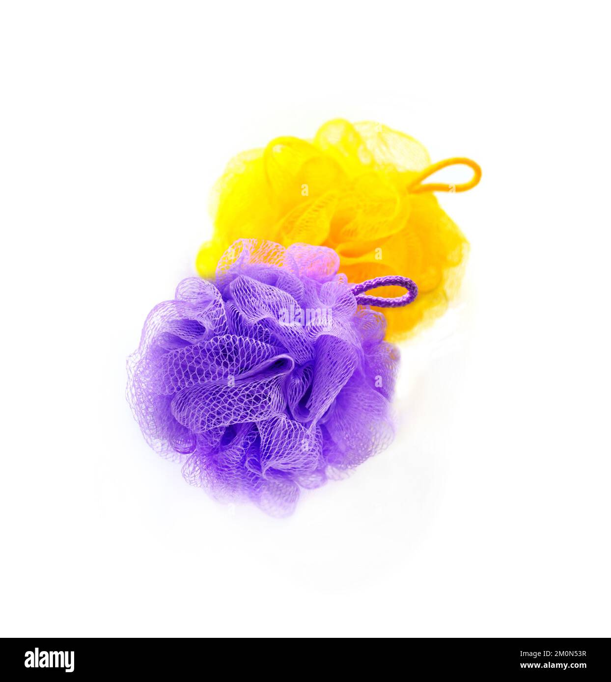 Two colored soft bath puffs on white background Stock Photo - Alamy