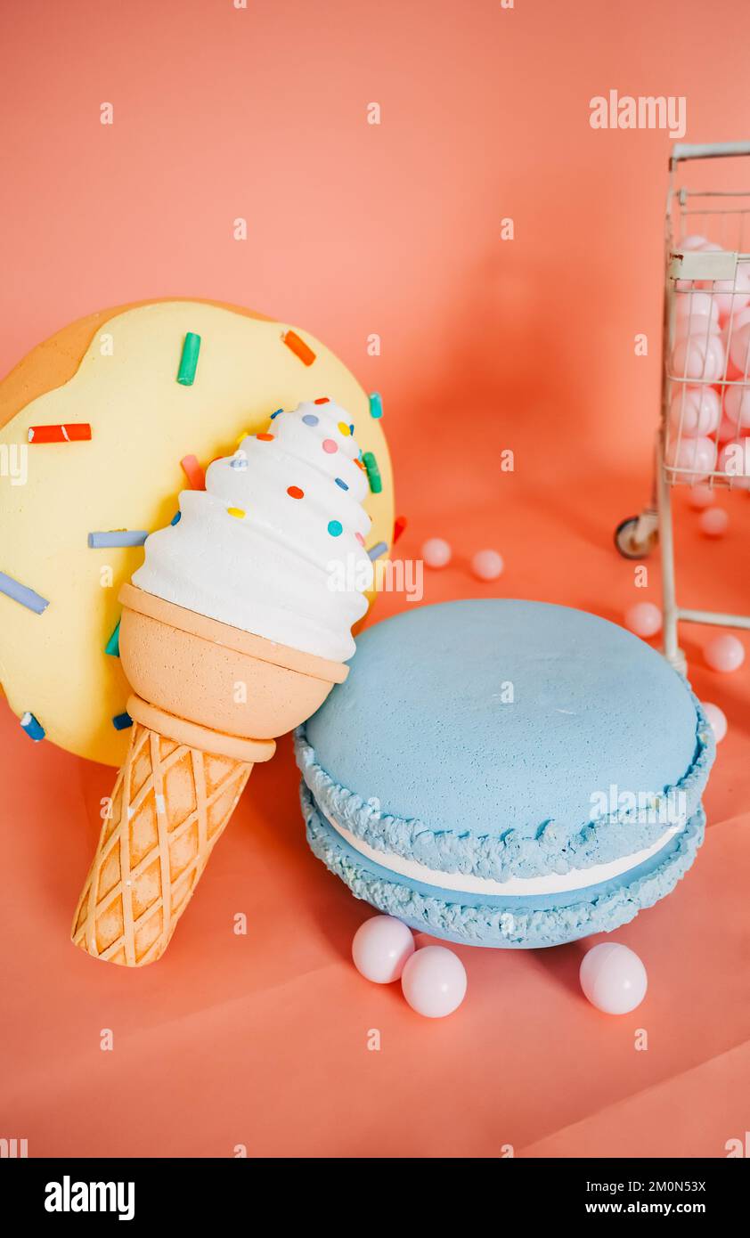 Big candies and sweets on pink background Stock Photo - Alamy