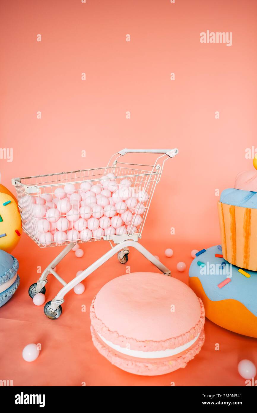 Big candies and sweets on pink background Stock Photo - Alamy