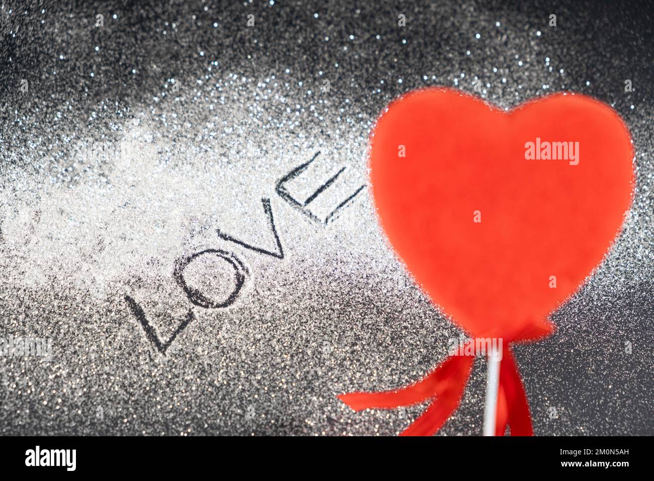 Valentine's Day, red loving heart on a black background with sequins ...