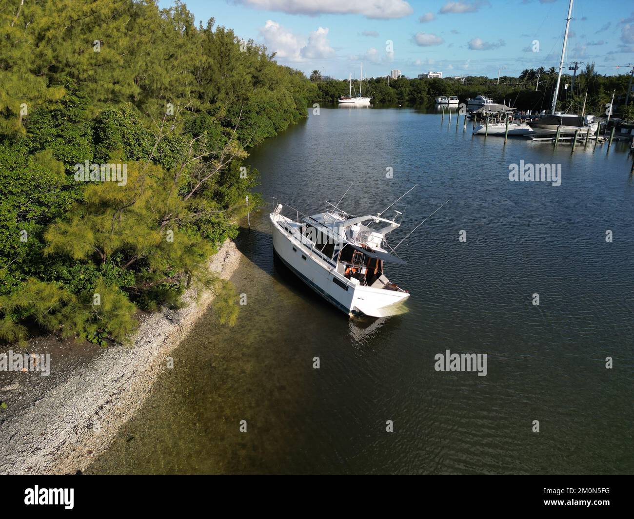 Aerial view of shipwrecked boat washed up on the shore next to a South ...
