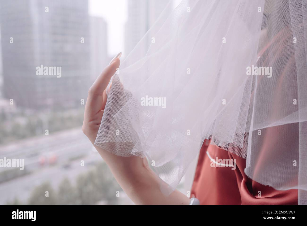 The white bridal veil on a woman standing at the window Stock Photo - Alamy