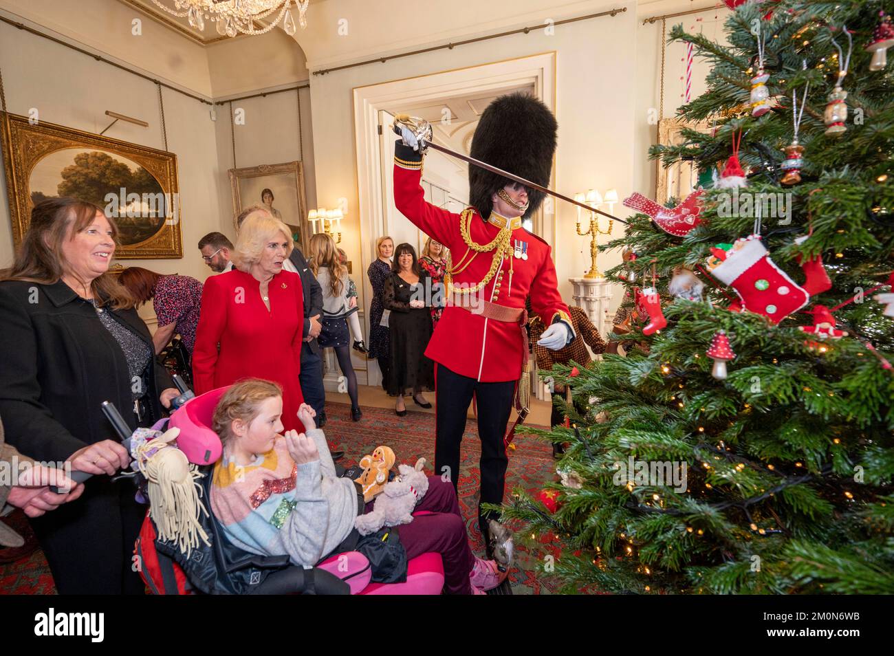 The Queen Consort, accompanied by children supported by Helen and ...