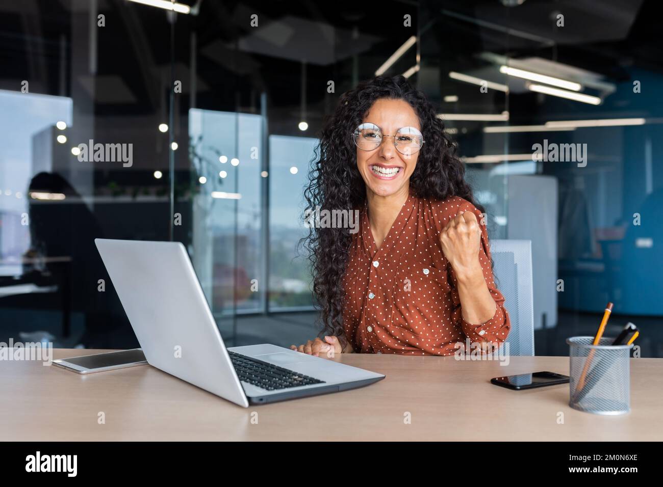 Portrait successful Hispanic business woman office worker with curly ...
