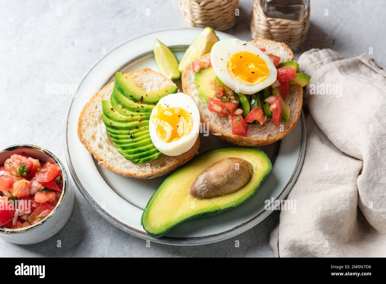 Healthy breakfast with avocado, egg, tomatoes and toasted bread on a ...