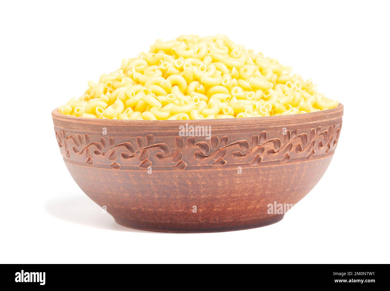 Italian pasta in brown clay bowl isolated on white background Stock ...