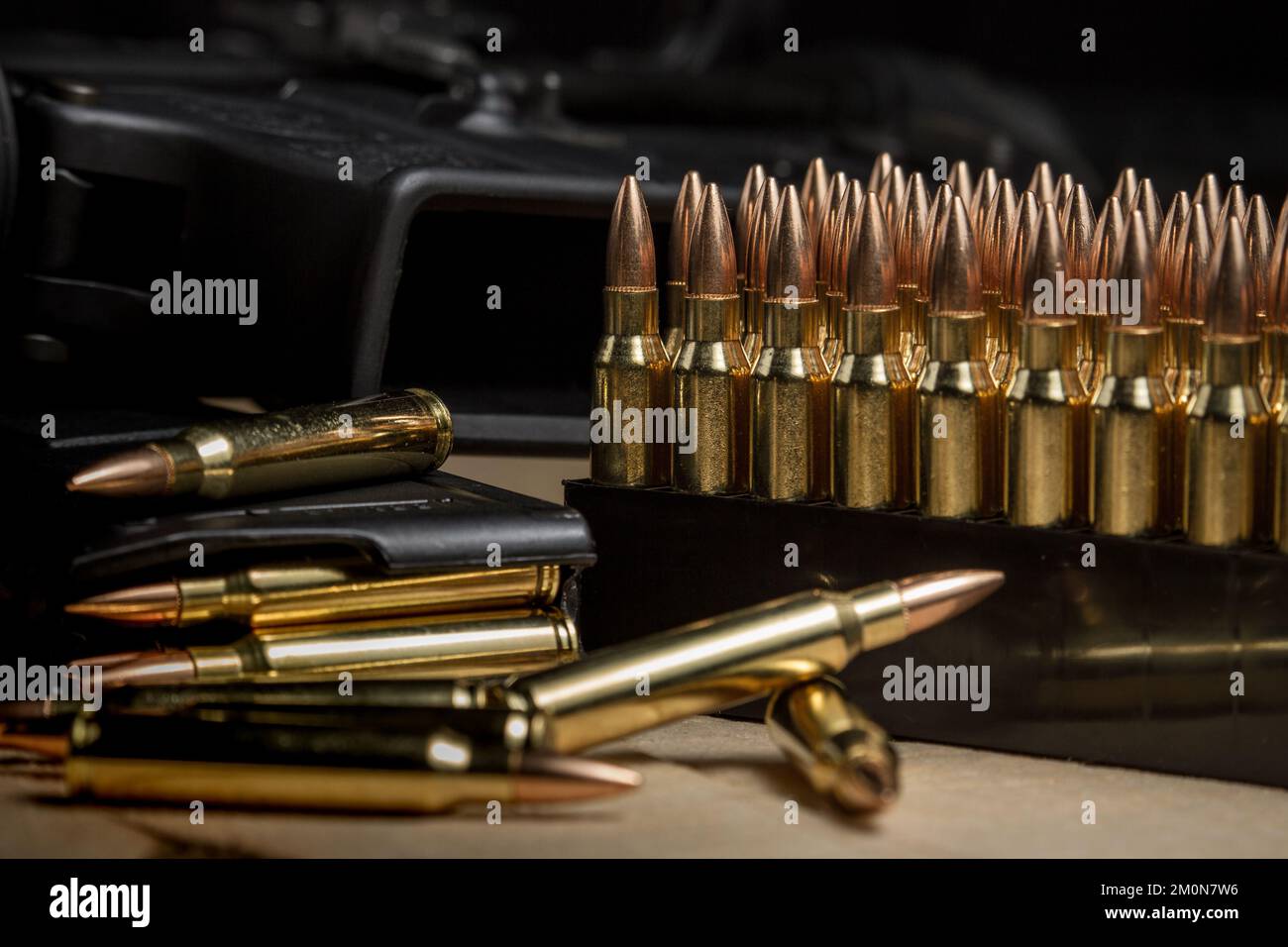 Various 223 (5.56x45mm) ammunition bullets in a loaded magazine next to ...