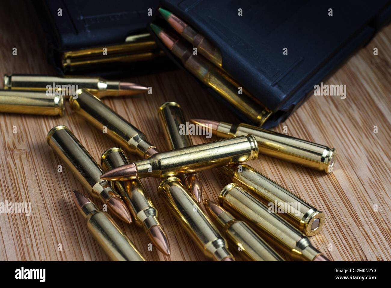 Loose 5.56x45mm (.223) AR-15 bullets laid out next to two loaded ...