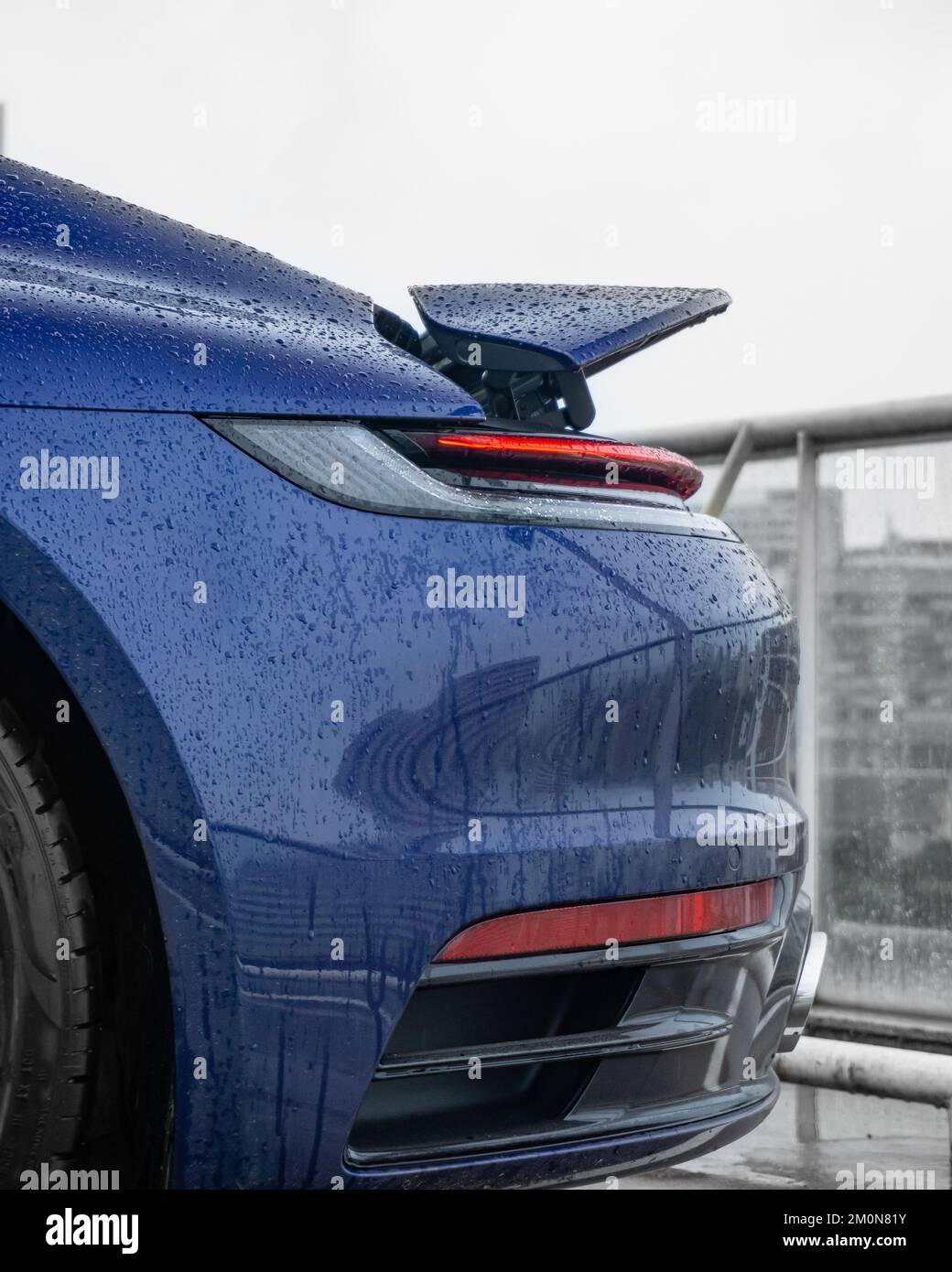 A vertical shot of a blue Porsche 911 Carrera S rear side view Stock ...