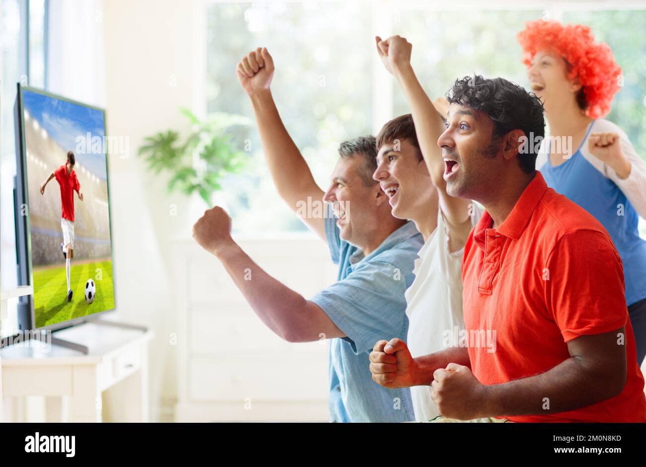 Group of football fans watch tv at home. Friends watching soccer match ...