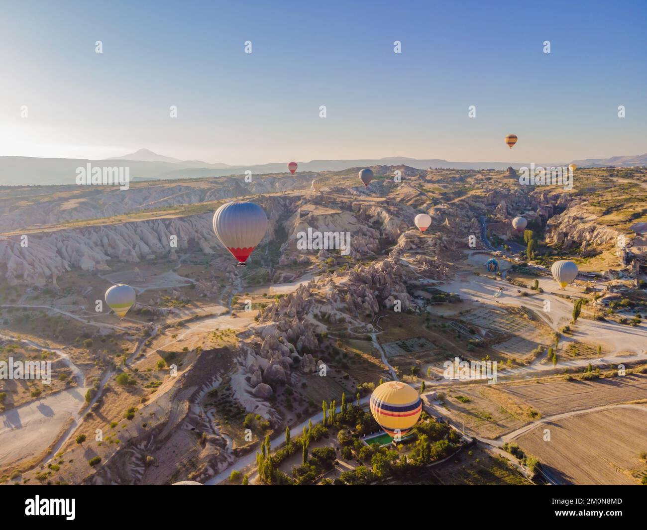 Colorful hot air balloons flying over at fairy chimneys valley in ...