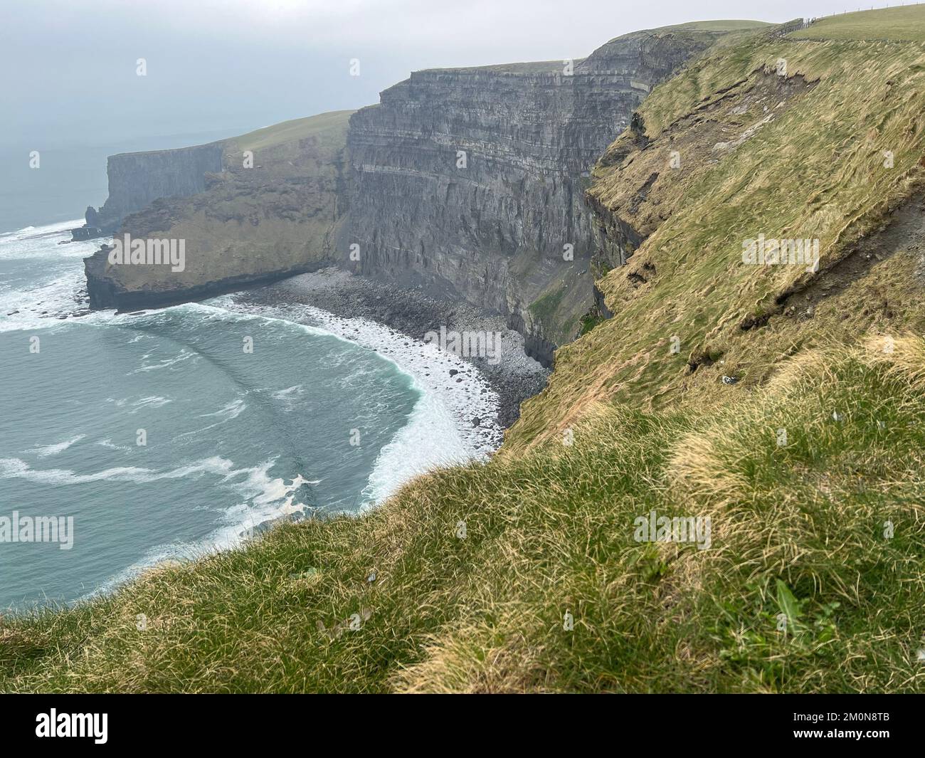 The cliff face and ocean at Cliffs of Moher in County Claire, Ireland ...