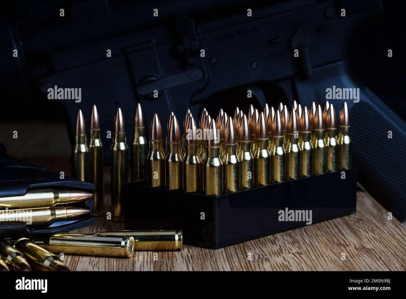 The 5.56x45mm bullets in box loosely arranged and in a full AR-15 ...