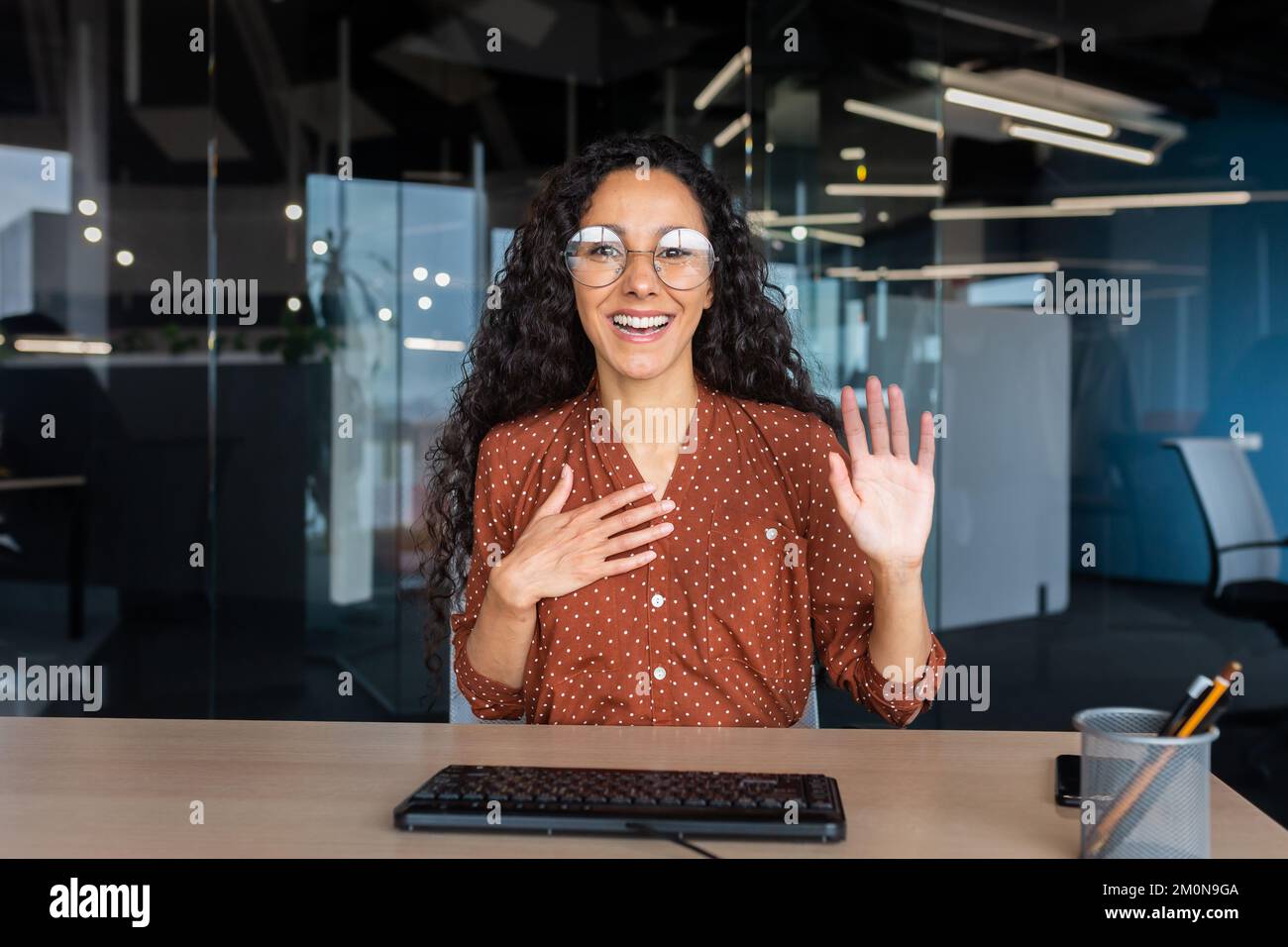 Online customer support video call, Latin American woman looking at web ...