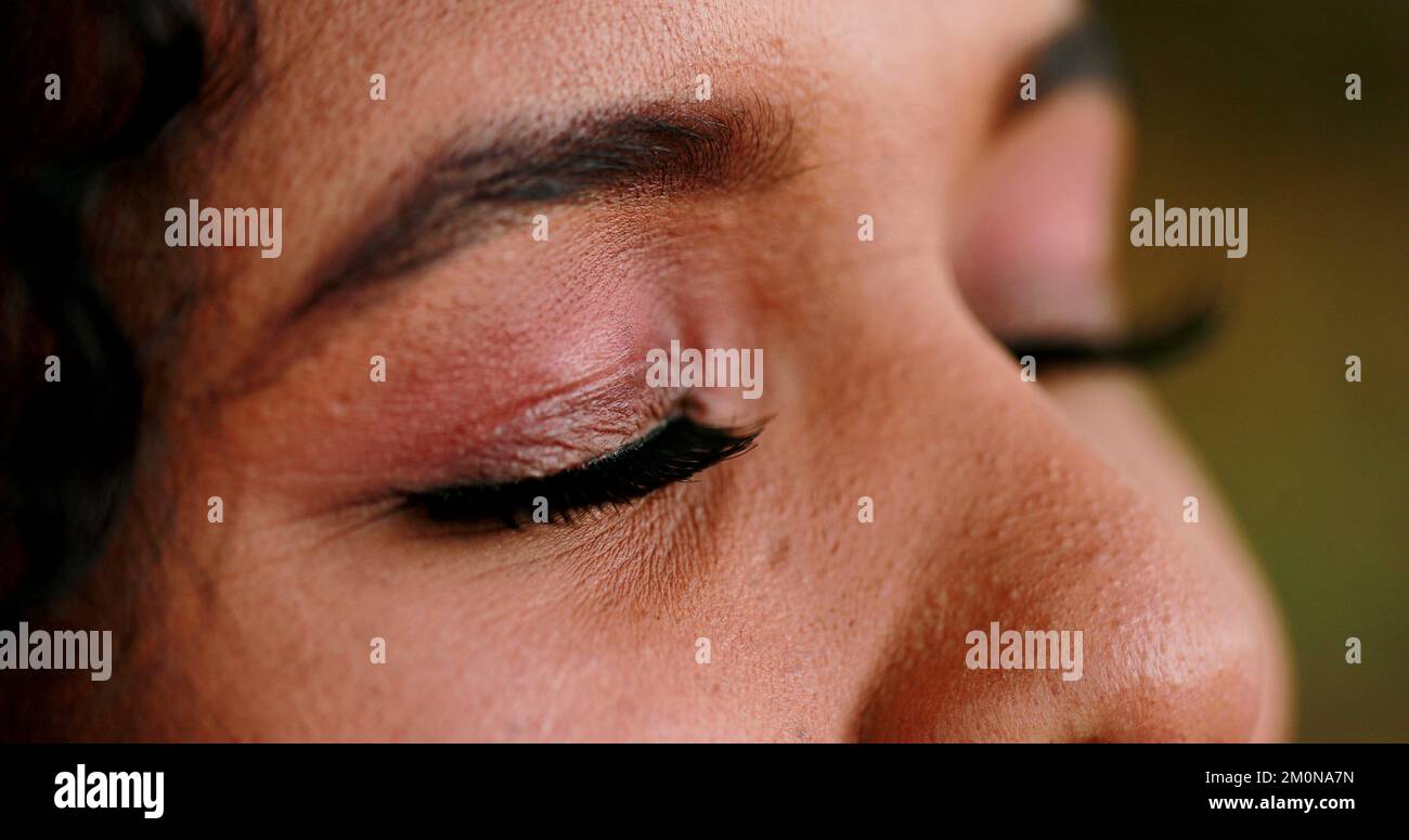Woman opening eyes in contemplation. Person relaxing in meditation ...