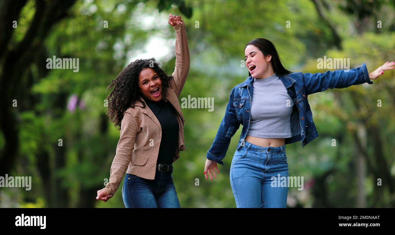 Two women jumping in the air with joy and excitement Stock Photo - Alamy