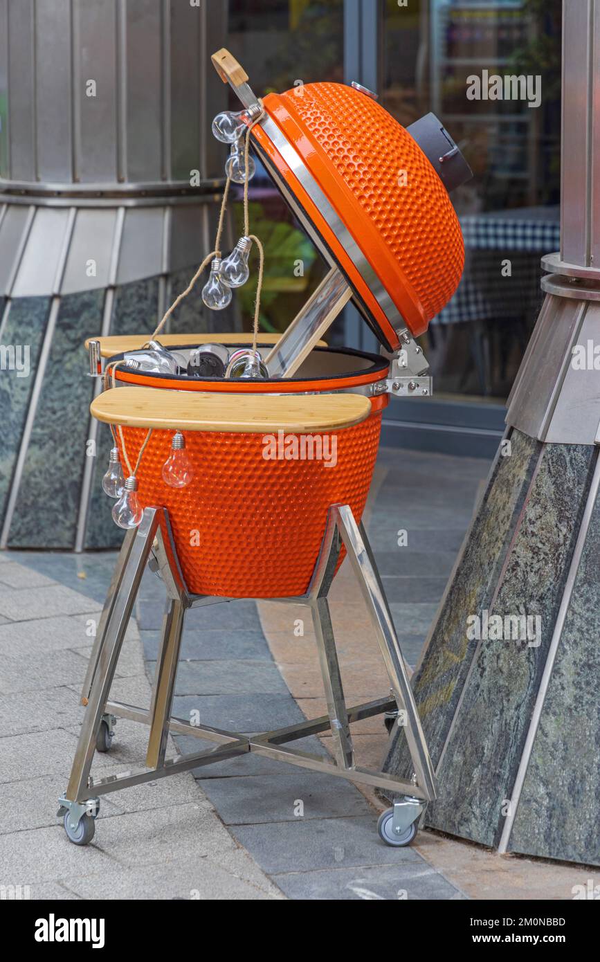 Large Orange Charcoal Barbecue Ceramic Kettle Grill on Wheels Stock ...