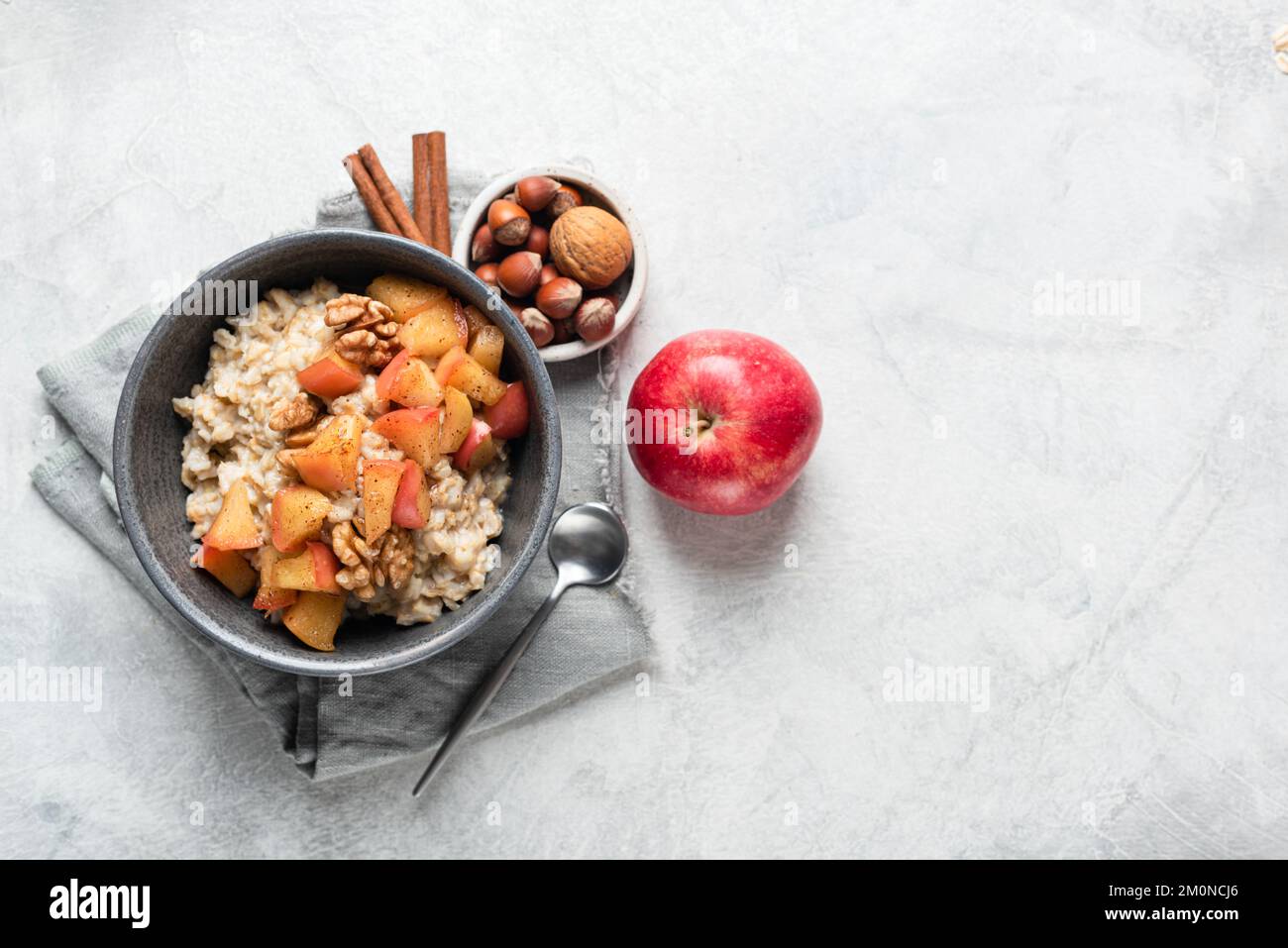 Apple cinnamon pie oatmeal porridge bowl on grey concrete background ...