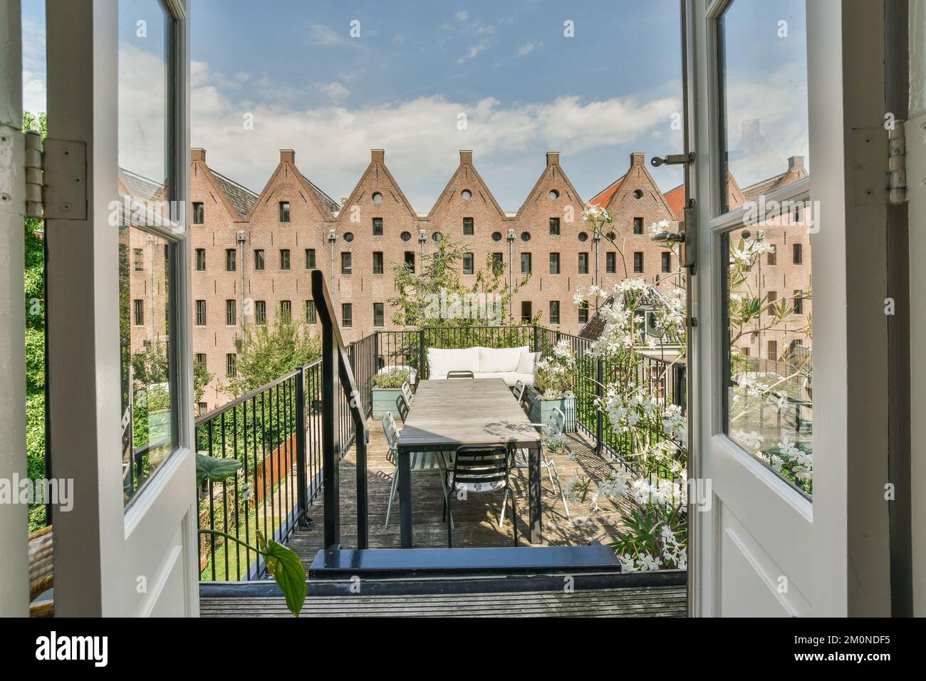 Panoramic view of buildings with trees from small balcony Stock Photo ...