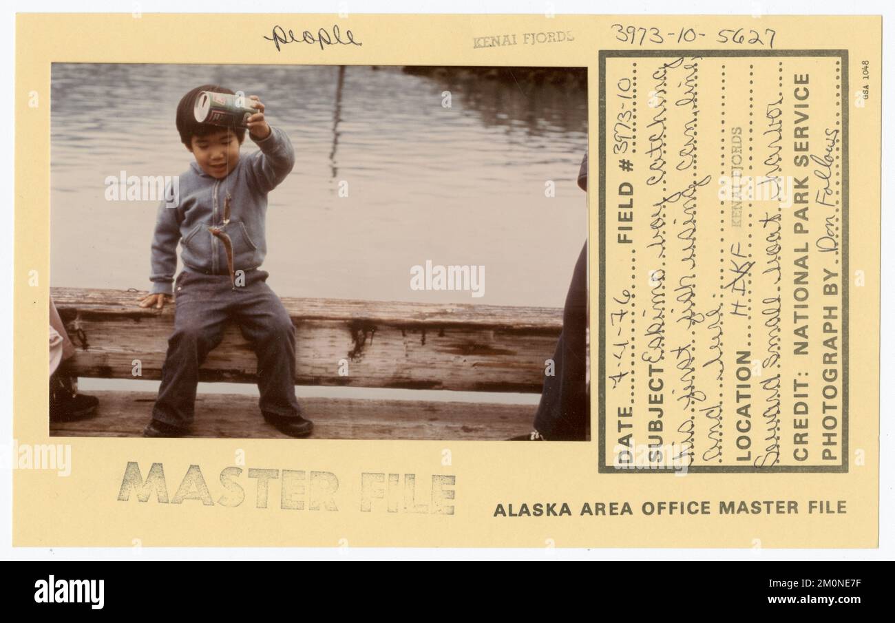 Eskimo boy catching his first fish using can line and lure. Alaska Task ...