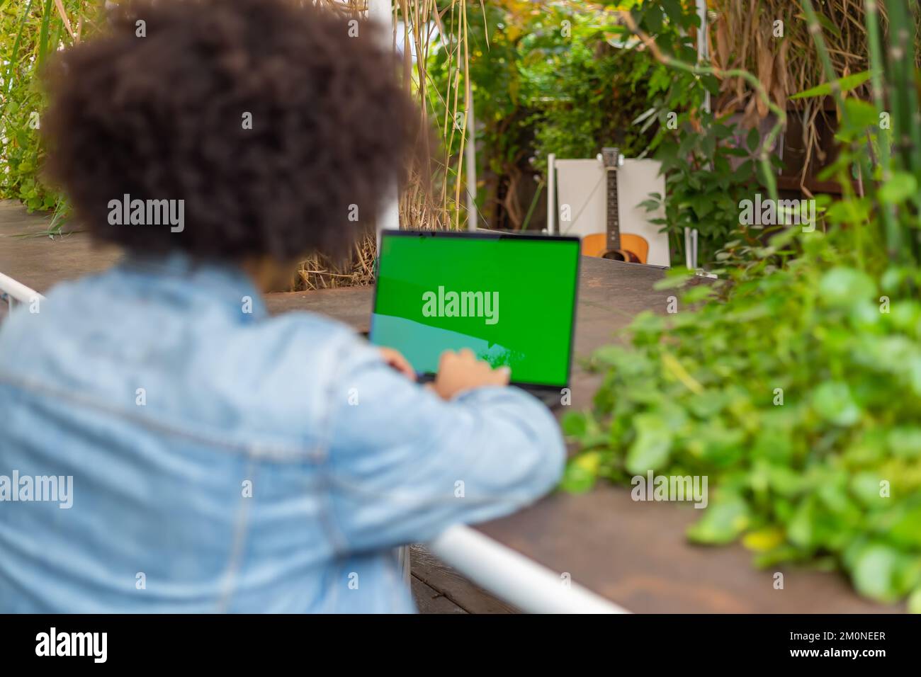 Young ethnic men , dressed in casual clothes, works on a laptop monitor ...