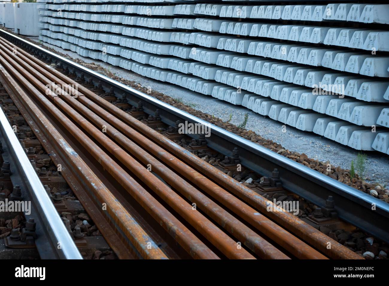 Expansion of railway lines. Train rails ready for laying and concrete ...