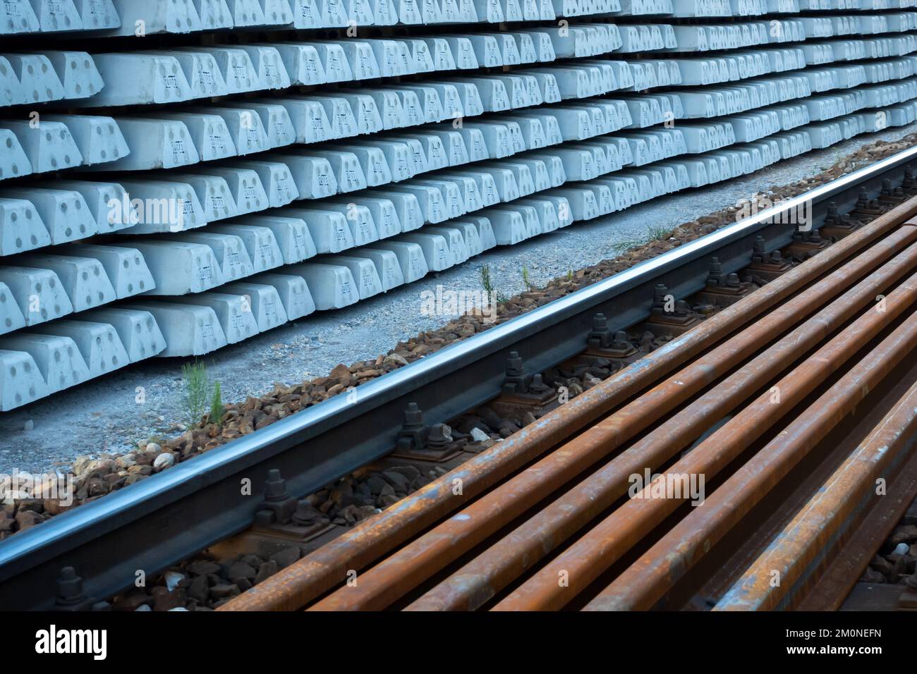 Expansion of railway lines. Train rails ready for laying and concrete ...
