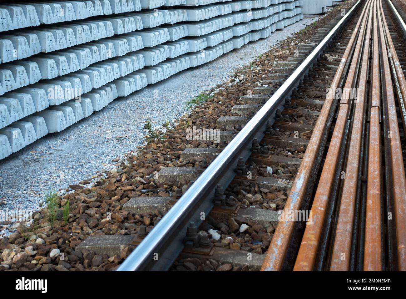 Expansion of railway lines. Train rails ready for laying and concrete ...