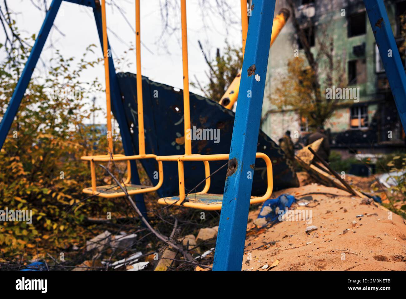 Playground after artillery shelling, Children's swings with traces of ...