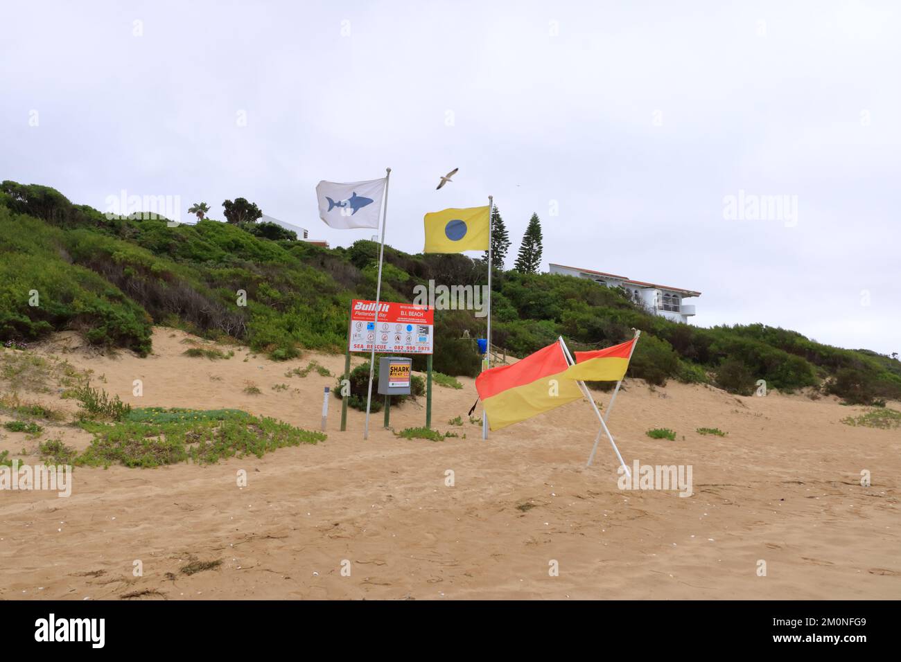 Lifeguard equipment in yellow and red colors and shark danger on the ...