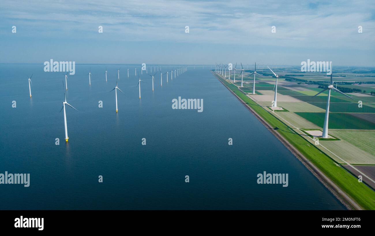 Windmill turbines at sea view from a drone aerial view from above at a ...