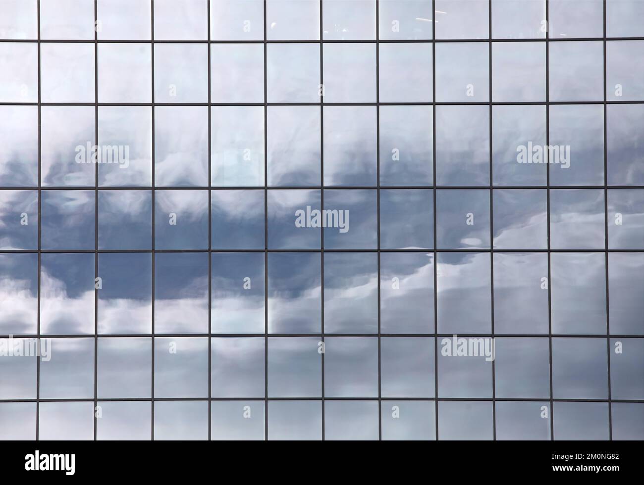Sky reflecting in windows of office building Stock Photo - Alamy