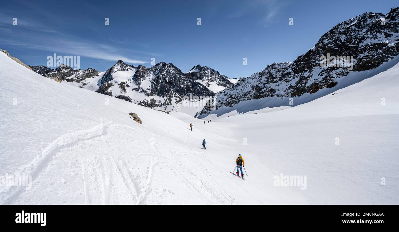 Ski tourers on the descent at Verborgen-Berg Ferner, behind summit ...