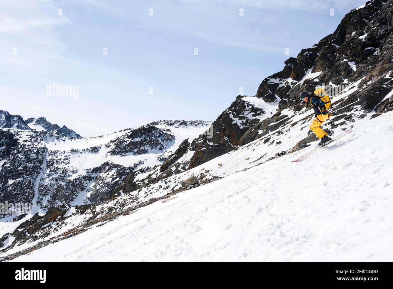 Skier descending a steep slope hi-res stock photography and images - Alamy