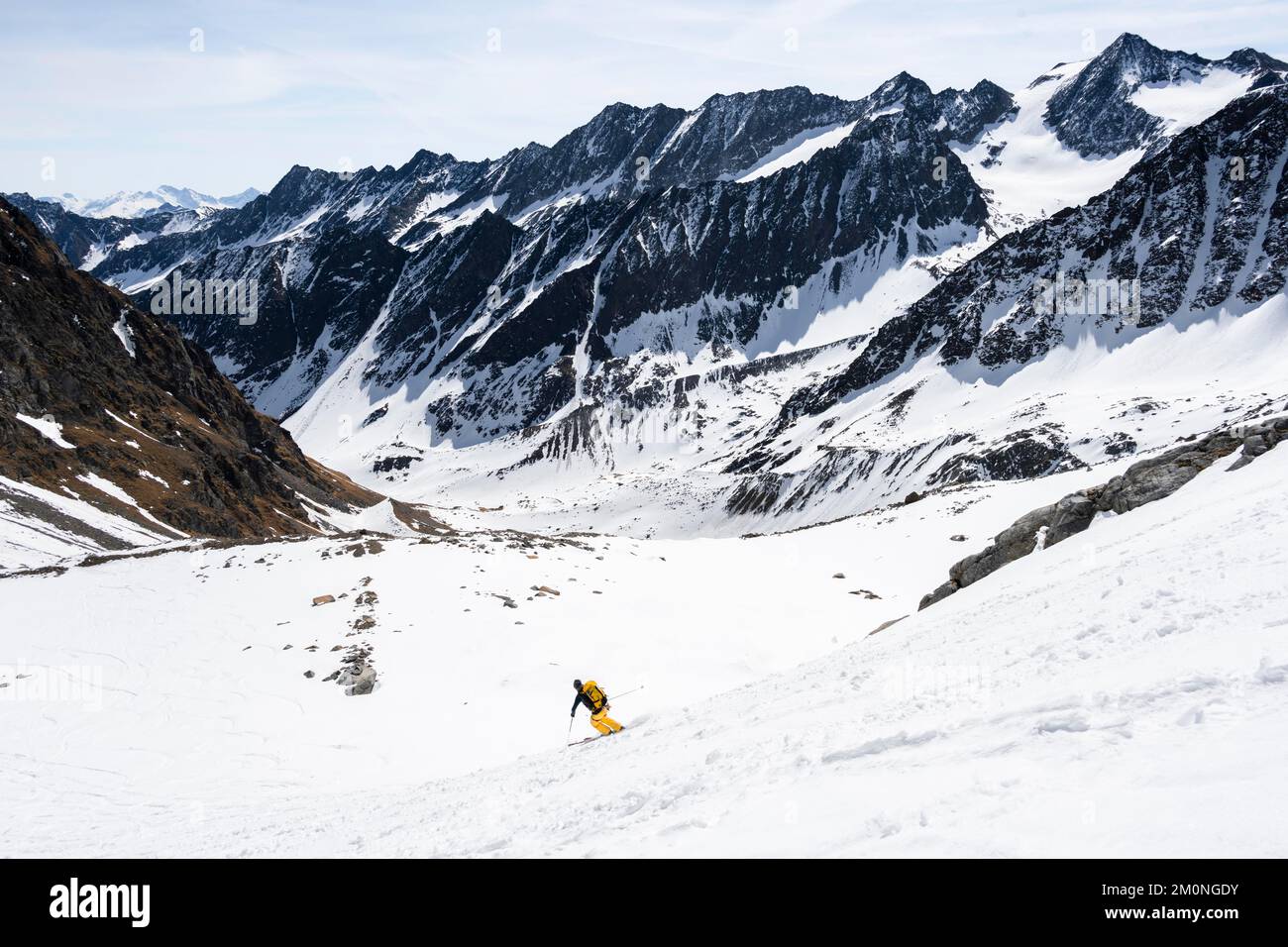 Skier descending a steep slope hi-res stock photography and images - Alamy